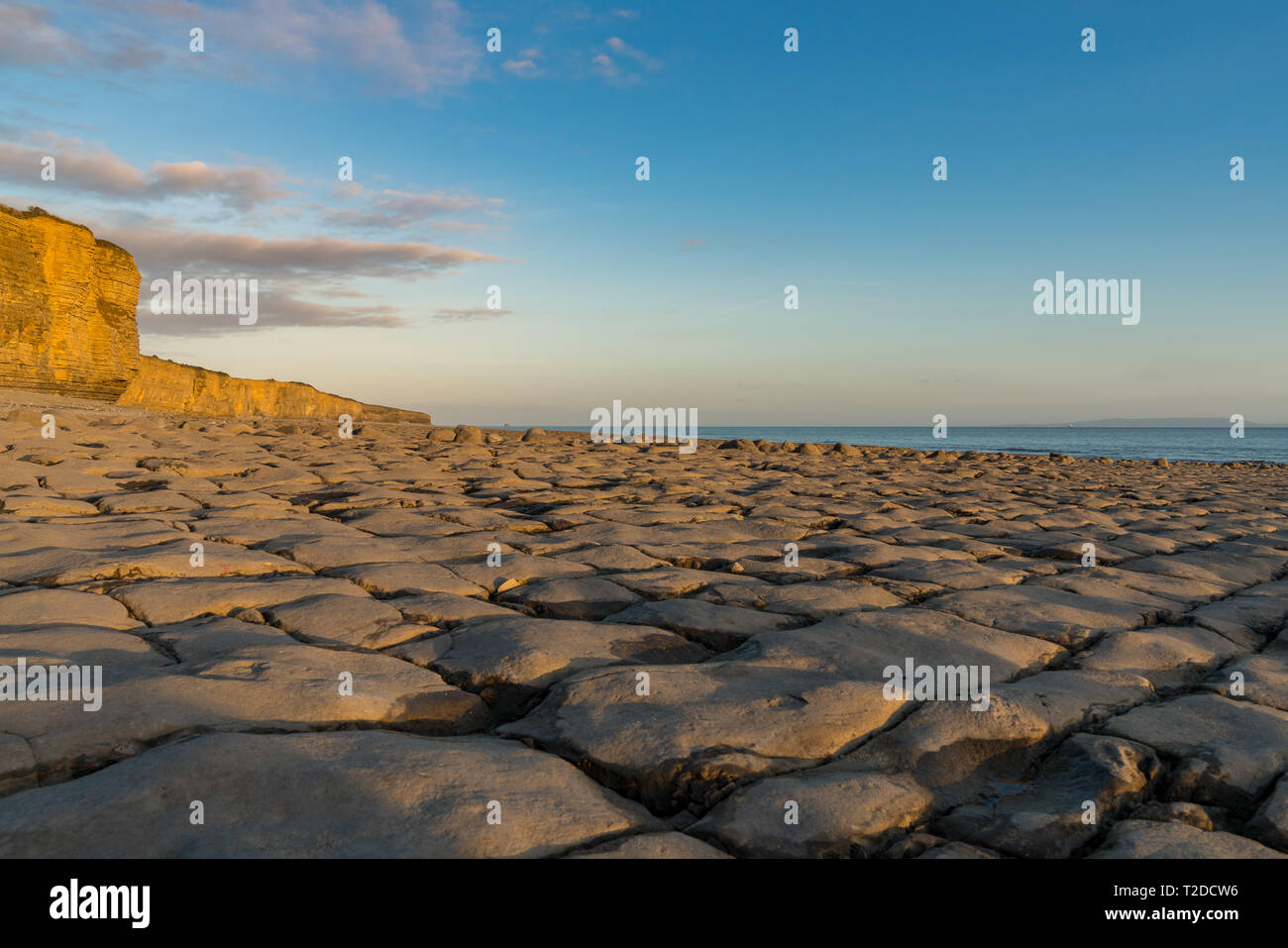 The stones and cliffs of Llantwit Major Beach in the evening sun, South ...