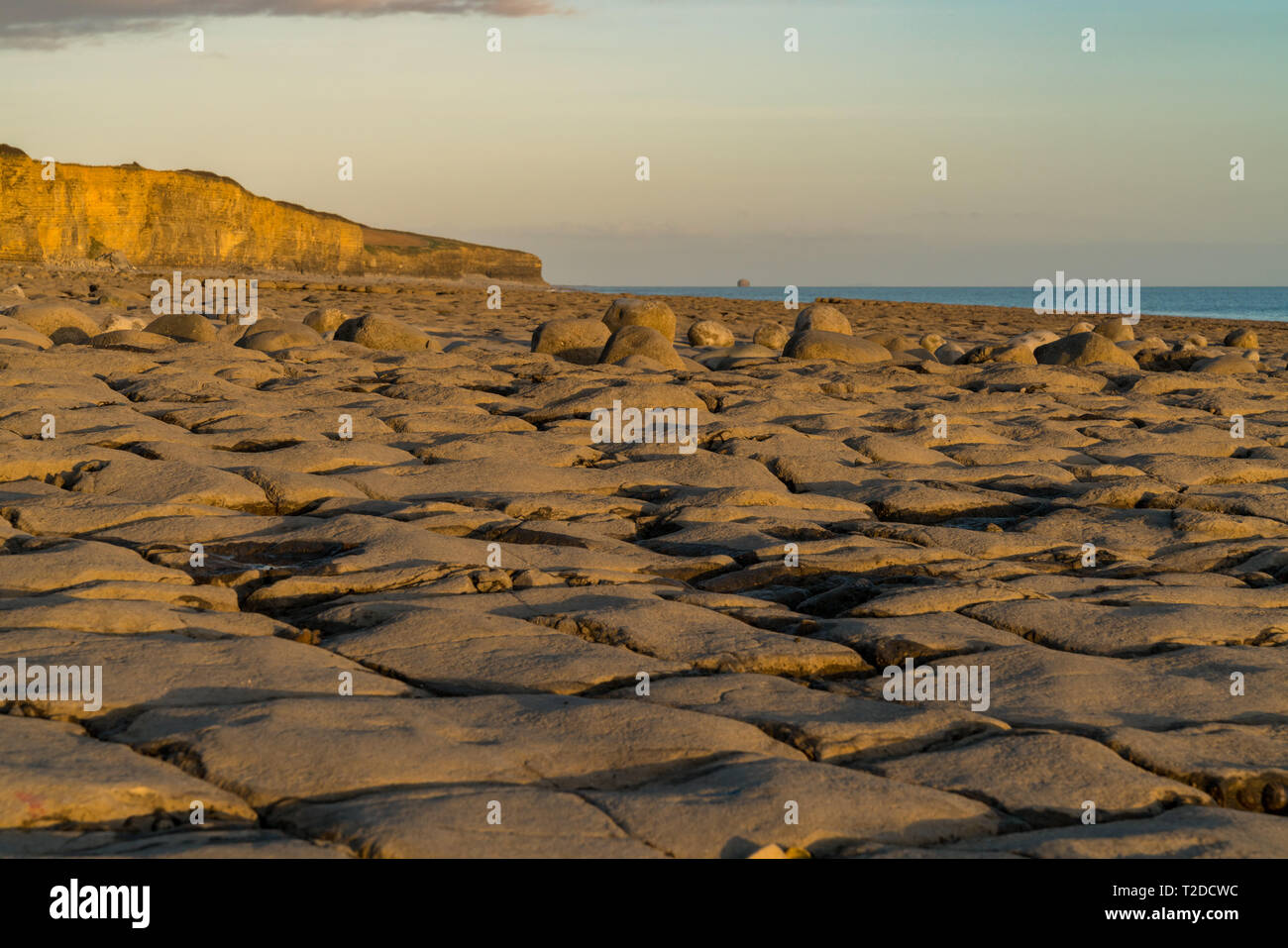 The stones and cliffs of Llantwit Major Beach in the evening sun, South ...
