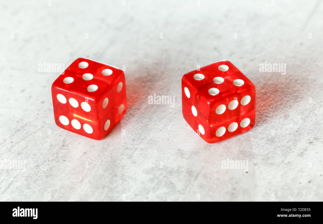 Two translucent red craps dices on white board showing Hard Ten number ...