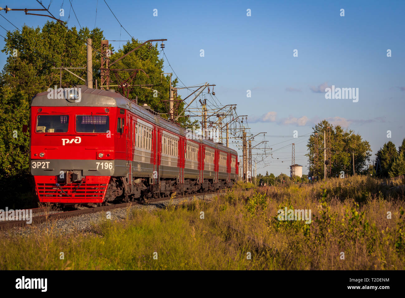 The train is on the rails in the evening. Russian railway. Electric ...