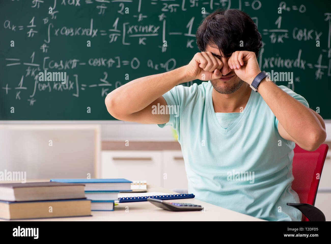 Young male student mathematician in front of chalkboard Stock Photo - Alamy