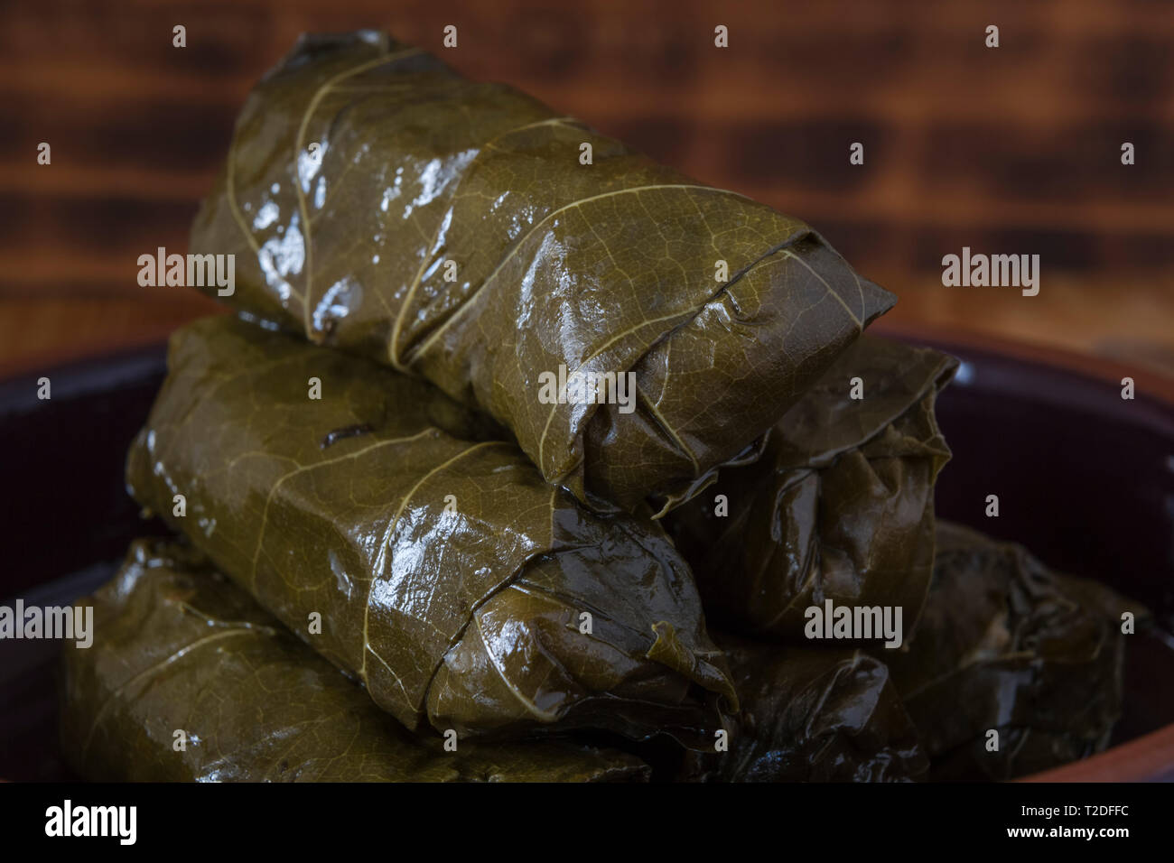 Close up of Greek stuffed vine leaves in glazed terracotta dish Stock ...