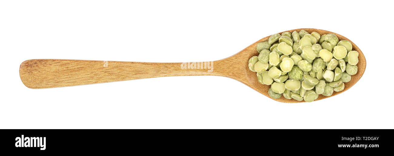 Green split peas in a wooden spoon isolated on white background. Top ...