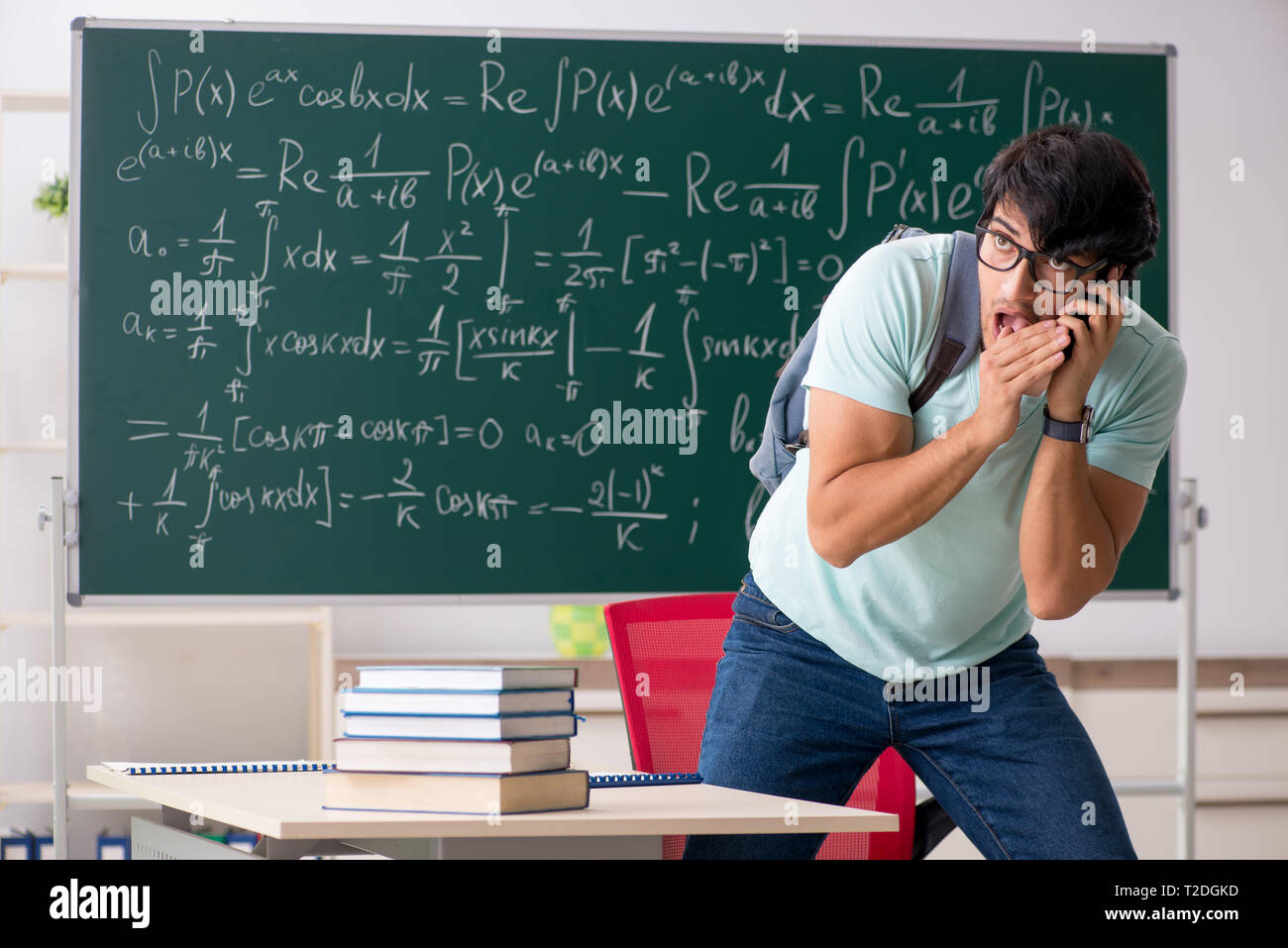 Young male student mathematician in front of chalkboard Stock Photo - Alamy