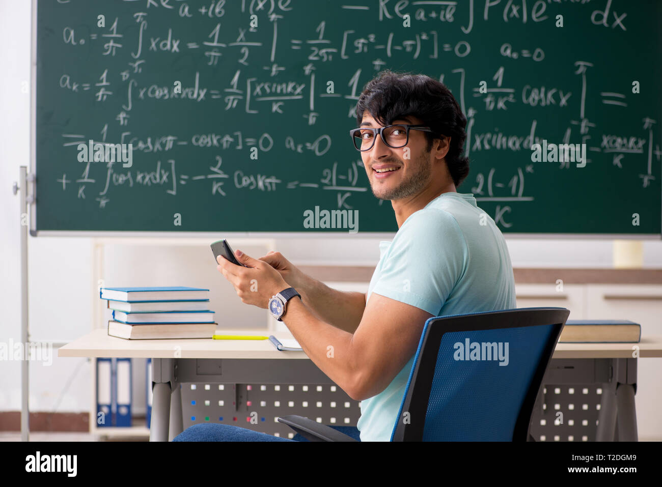 Young male student mathematician in front of chalkboard Stock Photo - Alamy