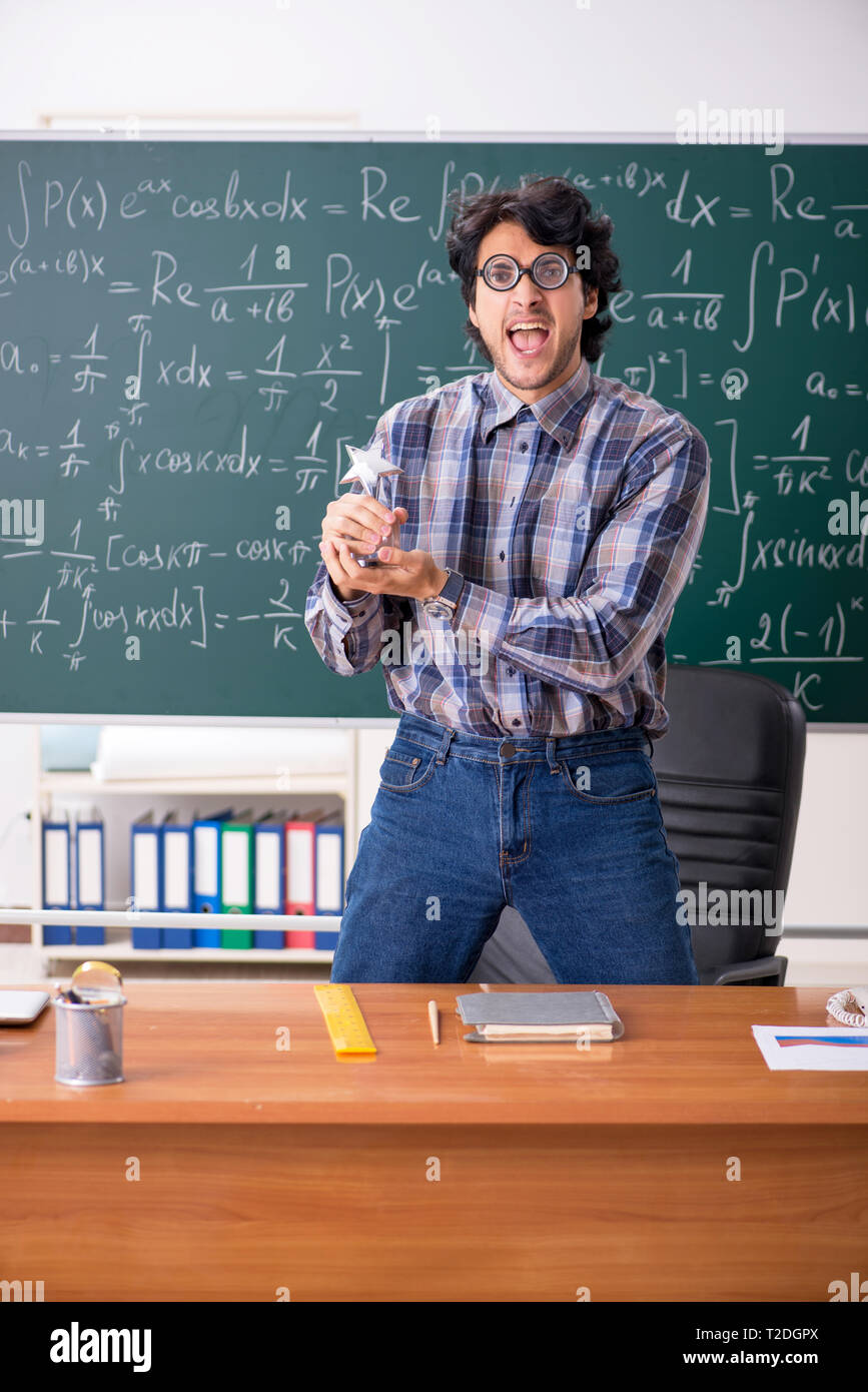 Funny male math teacher in the classroom Stock Photo - Alamy