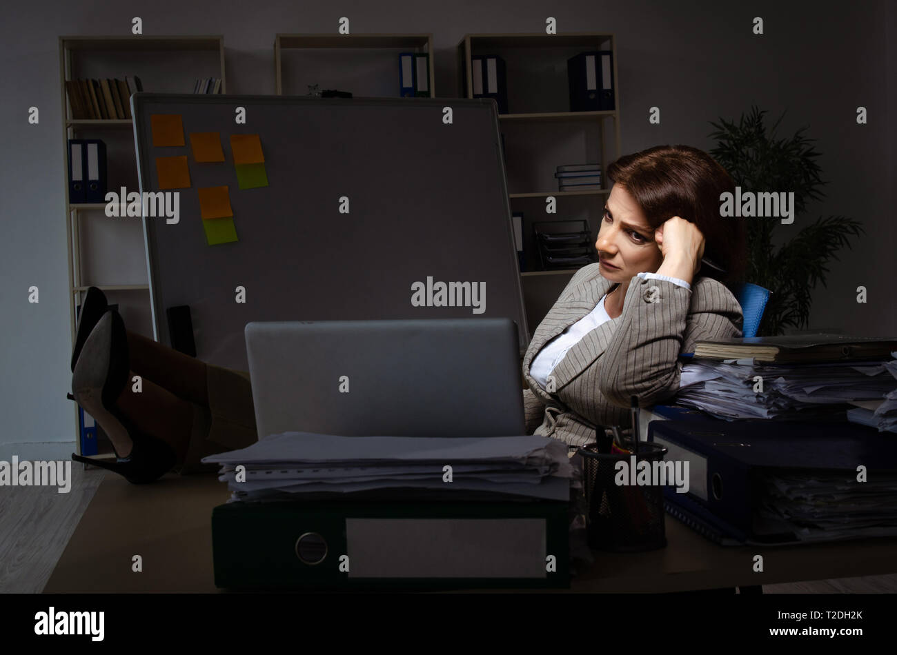 Female employee suffering from excessive work Stock Photo - Alamy