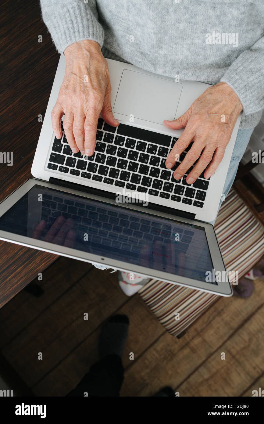 Closeup portrait of elderly woman standing on stool in an akward ...