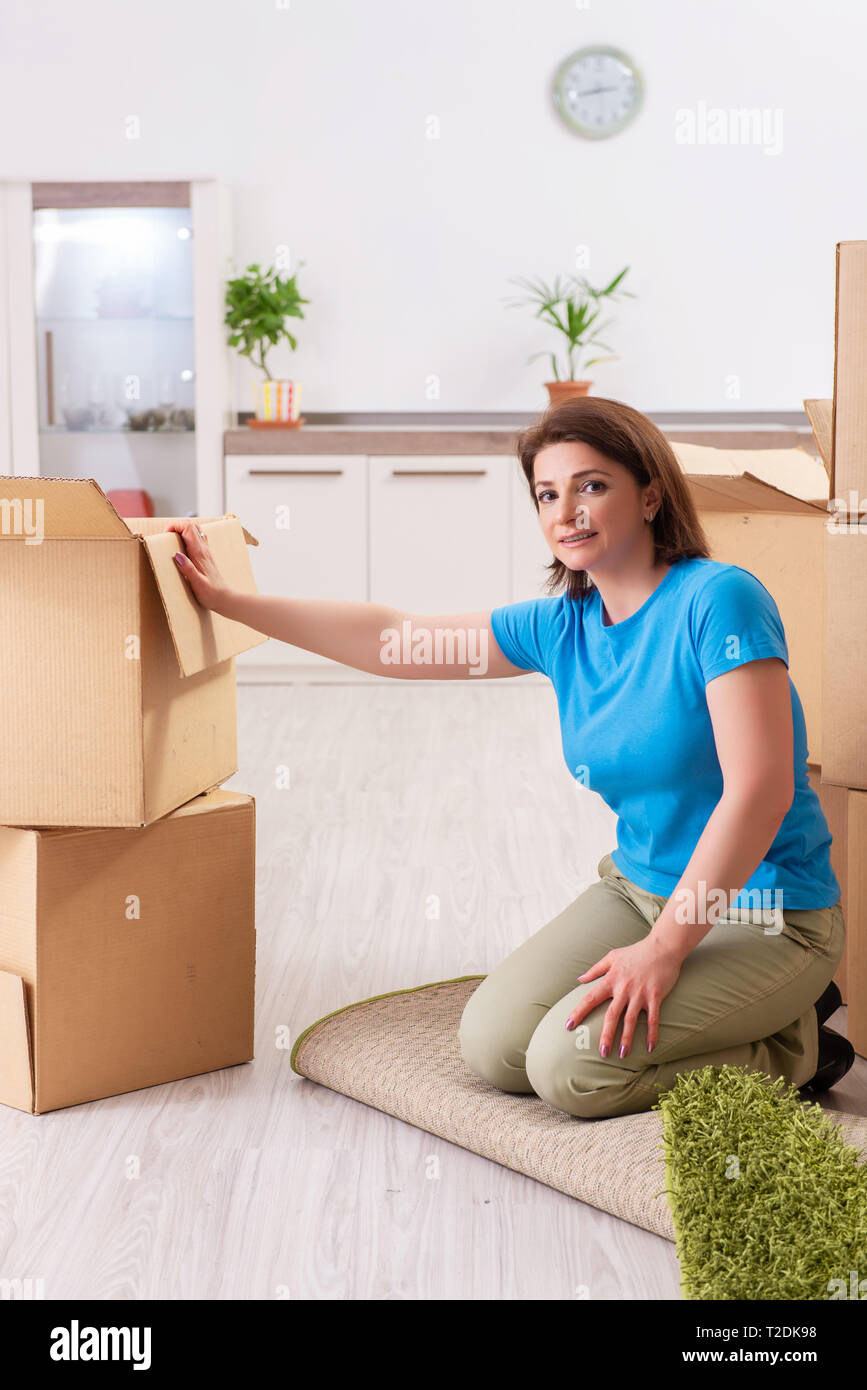 Middle-aged woman moving to new flat Stock Photo - Alamy