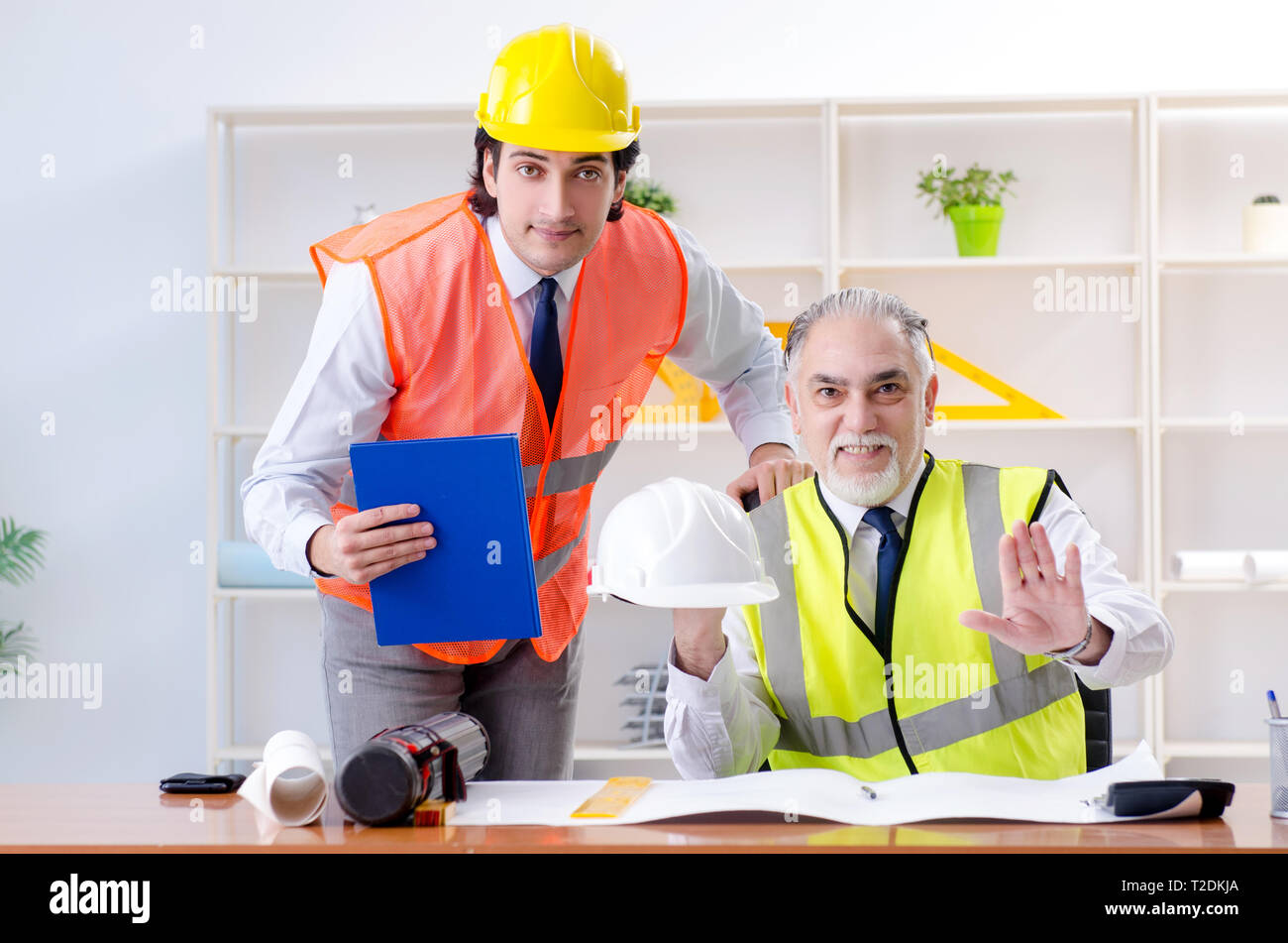 Two engineers colleagues working under project Stock Photo - Alamy