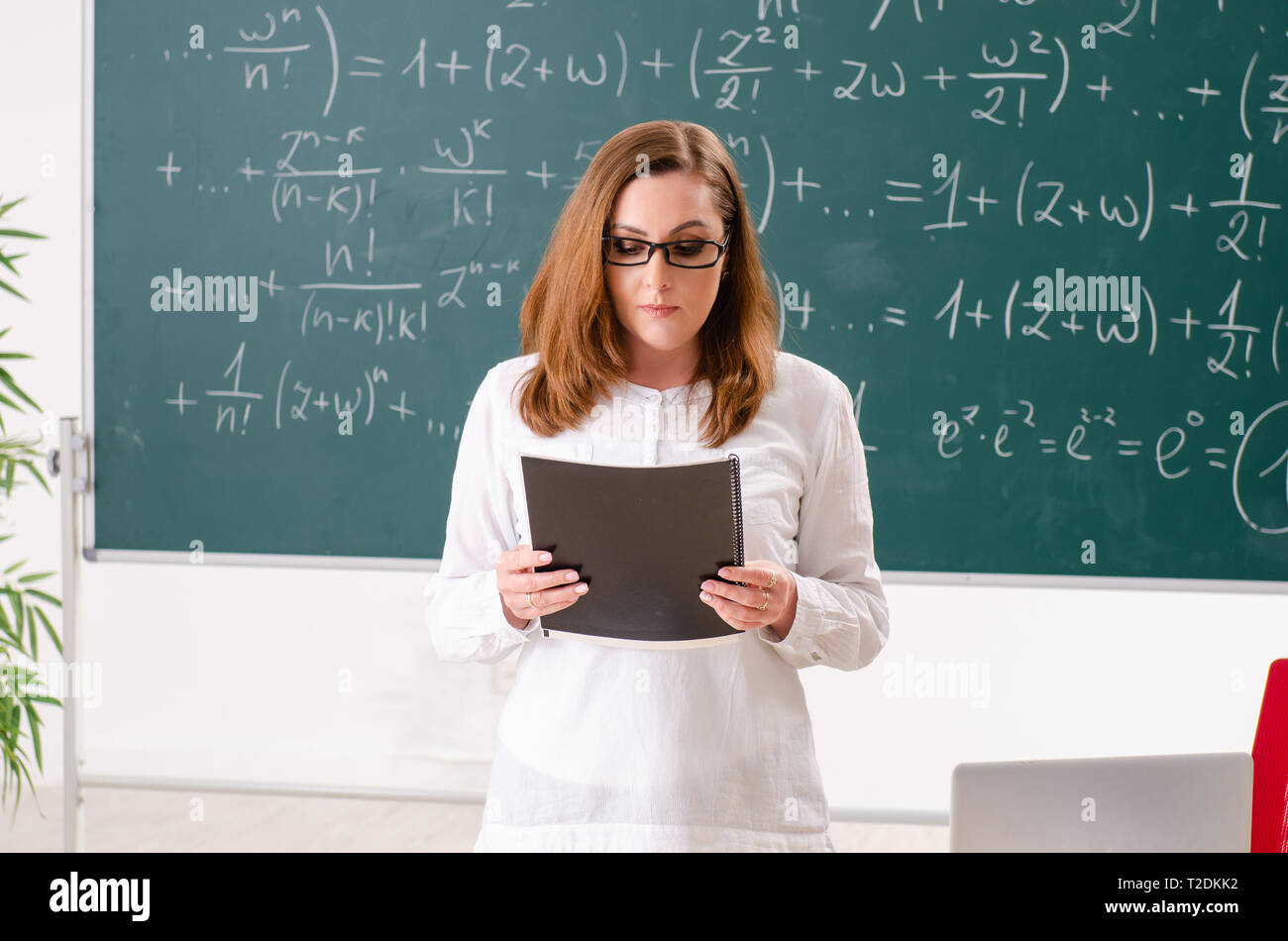 Female math teacher in the classroom Stock Photo - Alamy