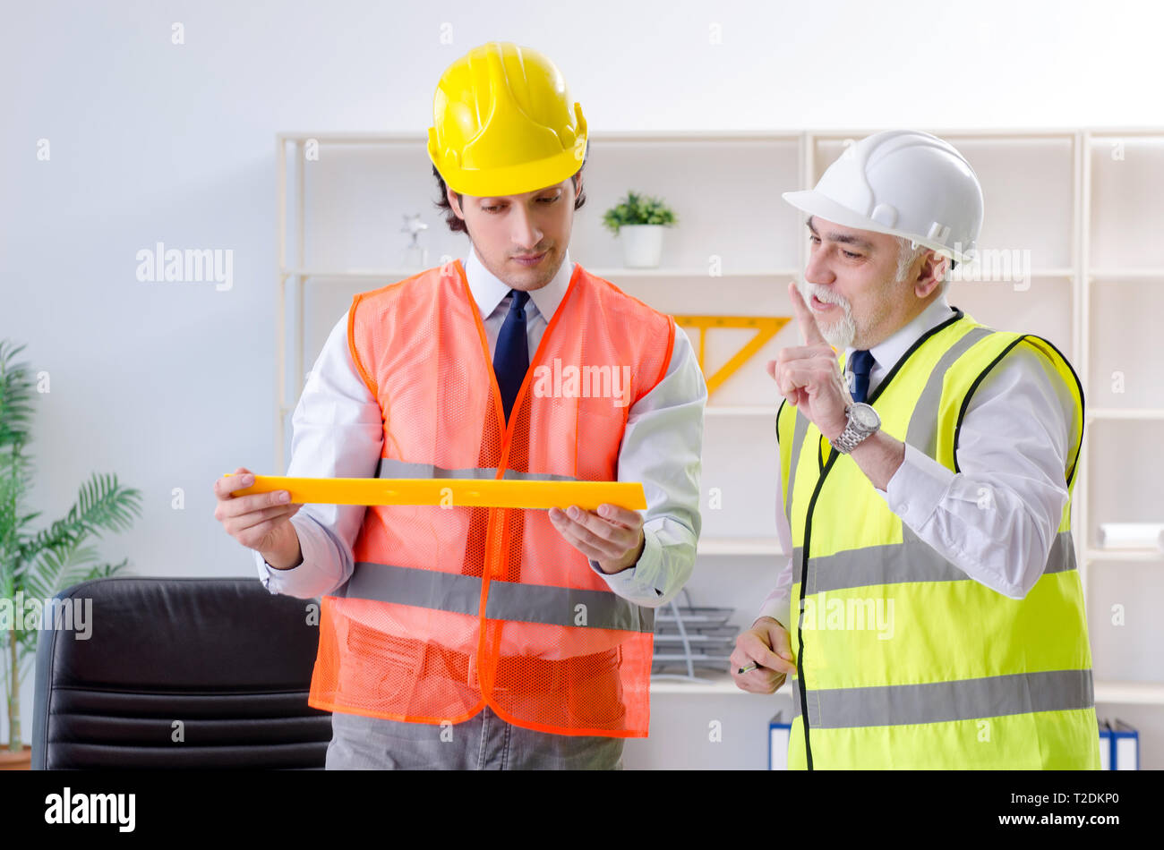 Two engineers colleagues working under project Stock Photo - Alamy