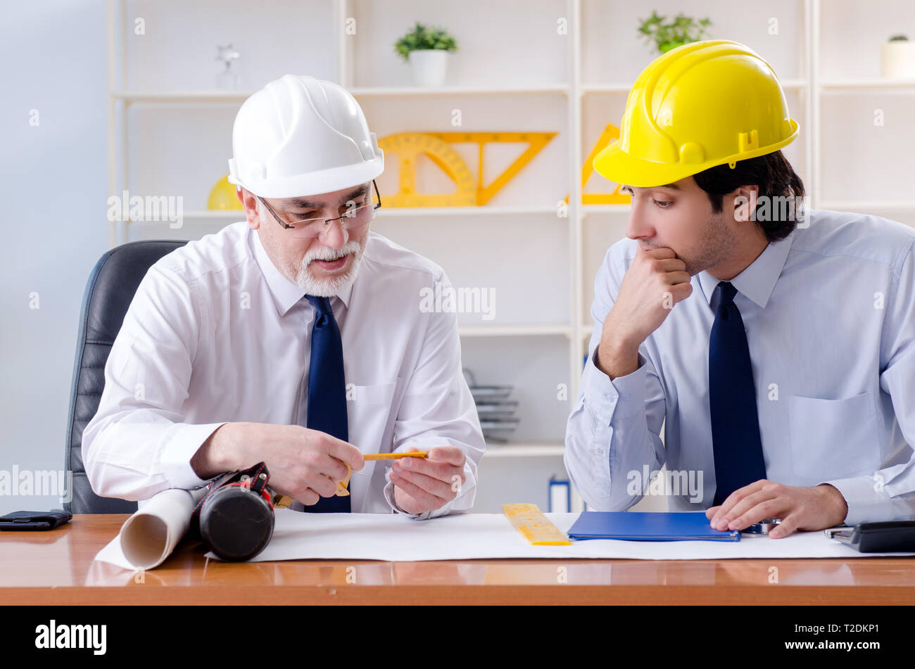 Two engineers colleagues working under project Stock Photo - Alamy