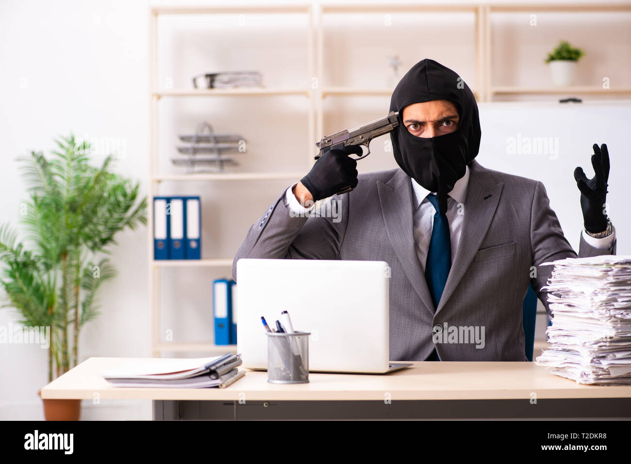 Male gangster stealing information from the office Stock Photo - Alamy