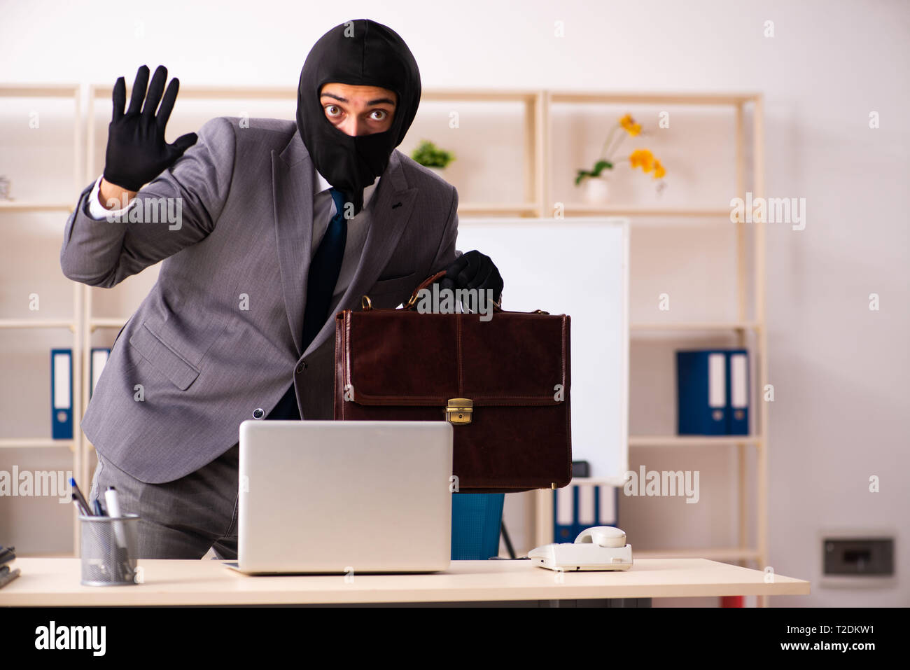Male gangster stealing information from the office Stock Photo - Alamy