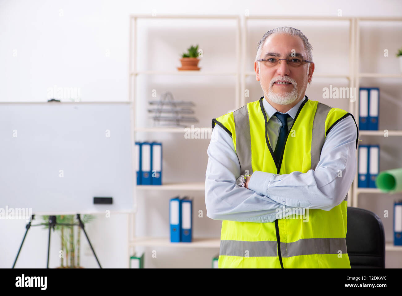 Aged construction engineer working in the office Stock Photo - Alamy