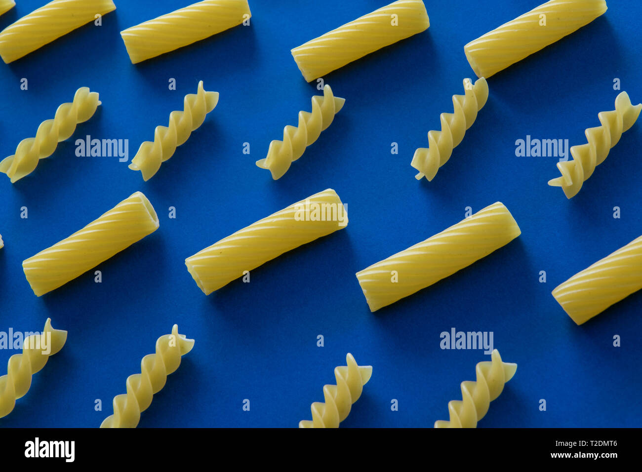 Abstract food background, Italian pasta products on blue background ...