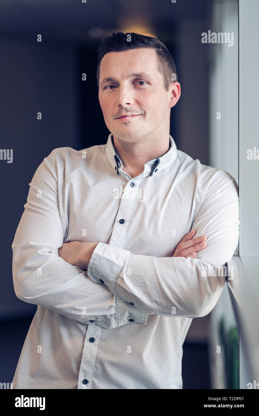 Portrait of a young confident professional in the office environment ...