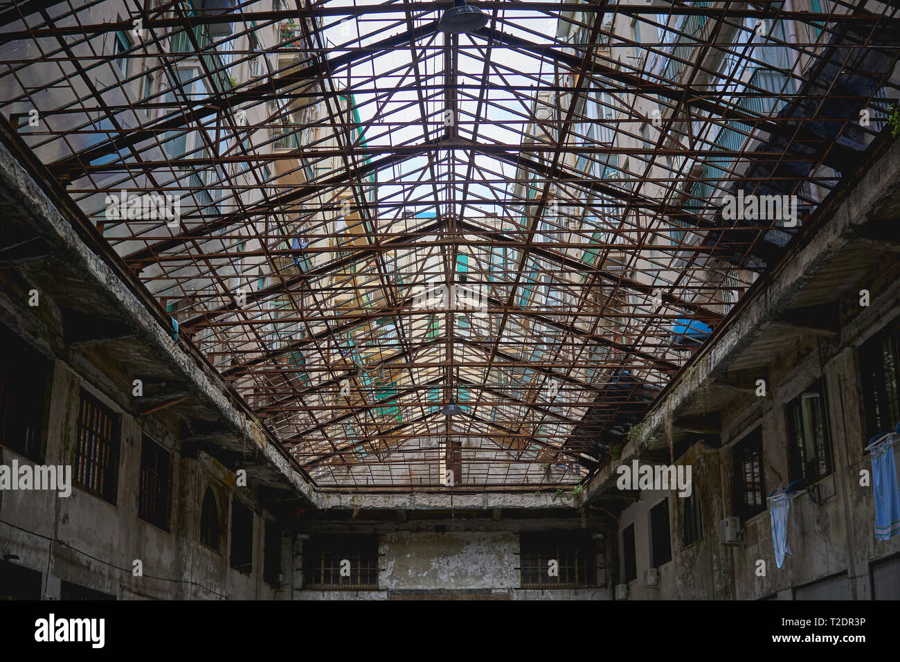 Abandoned industrial building with a rusty steel truss roof. Landscape ...