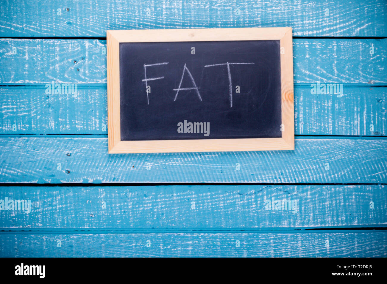 Weight loss concept showing a chalboard reading fat Stock Photo - Alamy