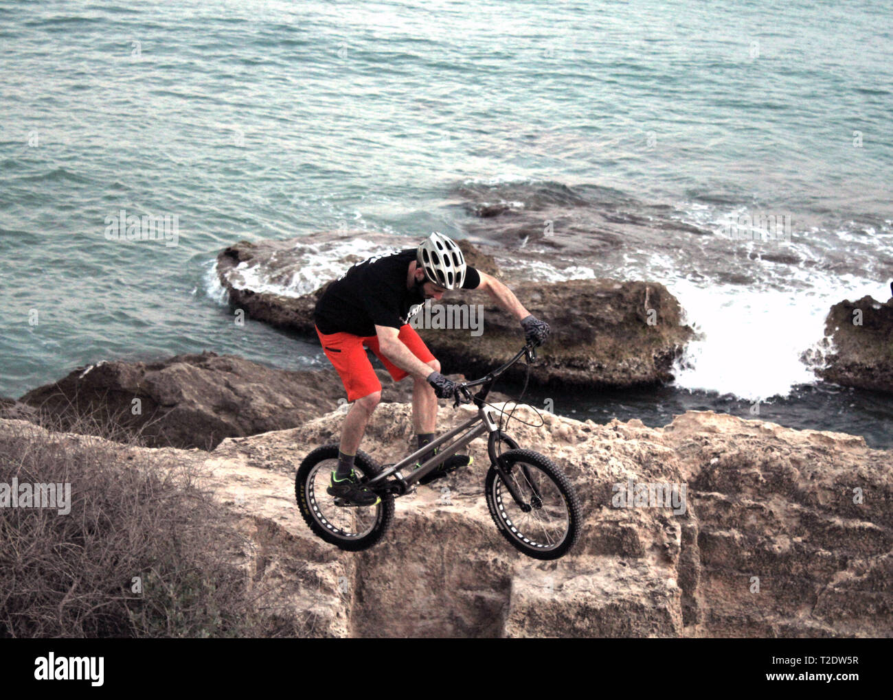 Trials mountain Bike on rocky coast over sea Stock Photo - Alamy