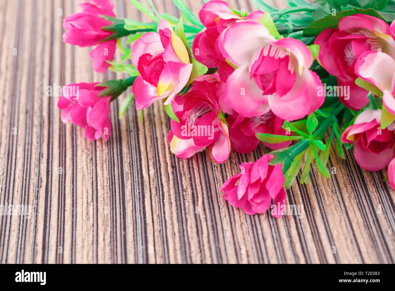 Pink artificial flowers on cloth background, closeup picture Stock ...