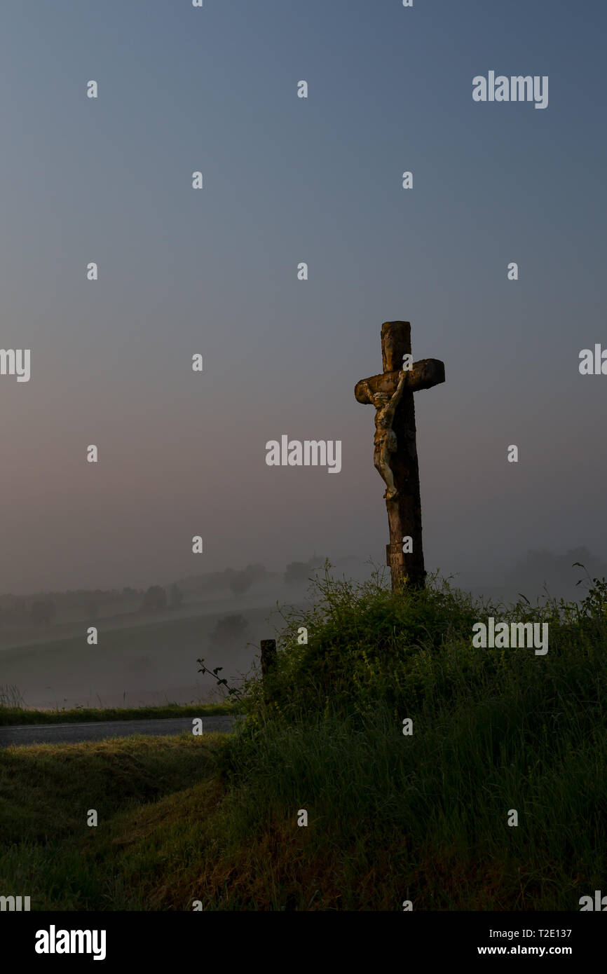 Crucifix cross with Christ on a misty morning Stock Photo - Alamy