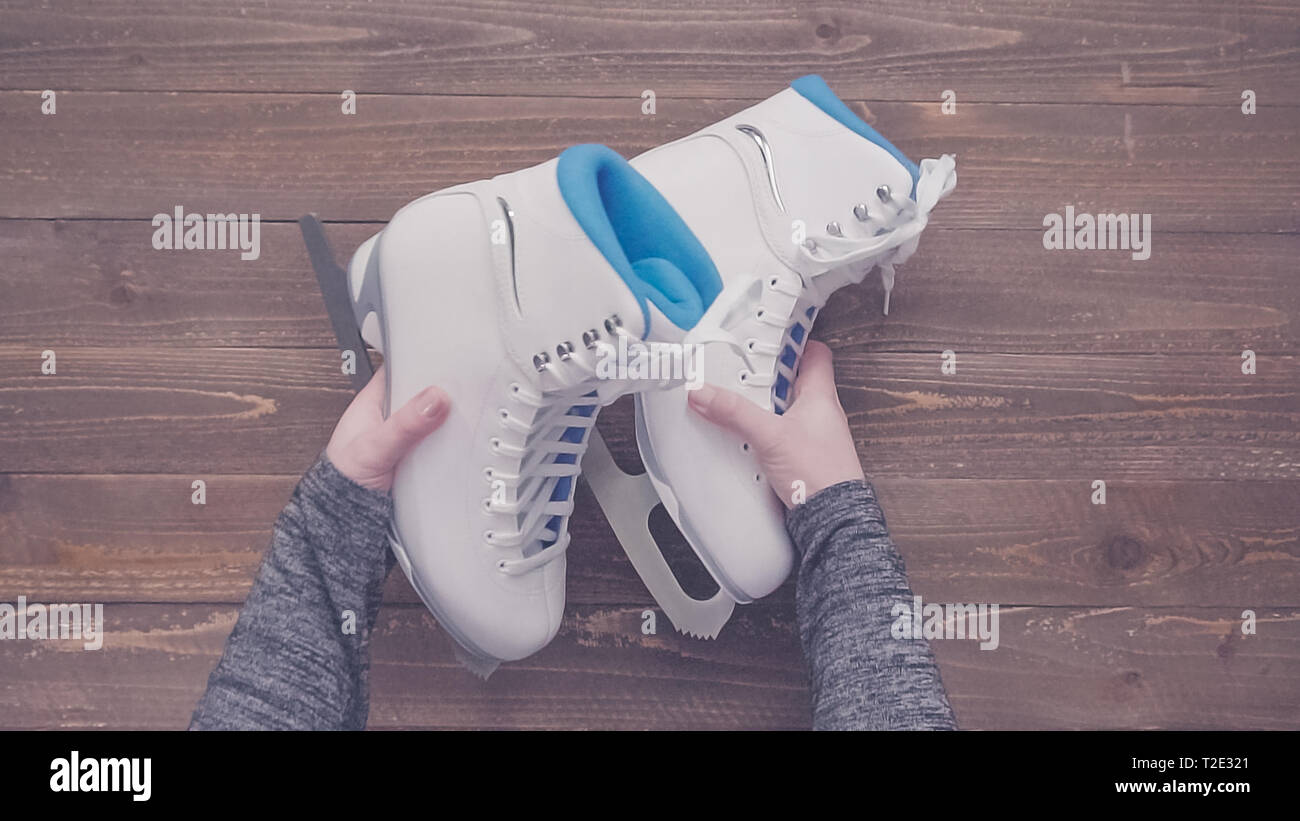 Flat lay. White figure skates on a wooden boards Stock Photo - Alamy