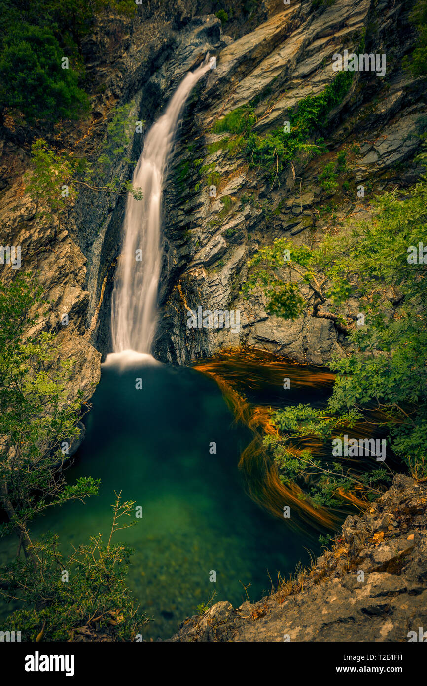 Incredible high waterfall falling through the cliffs on Fonias river on ...