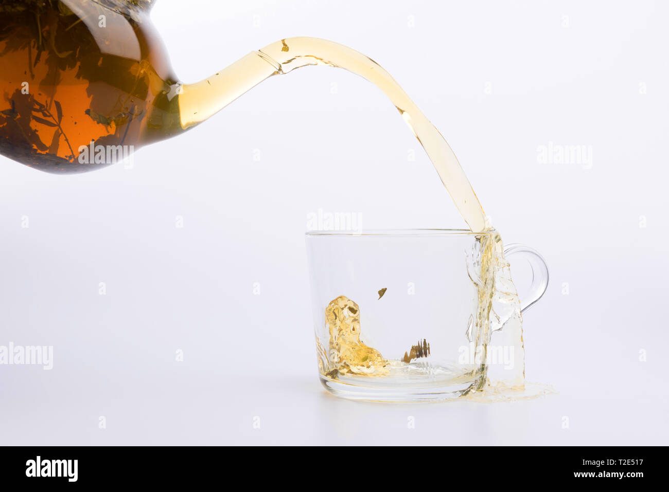Splash in glass cup of green tea isolated on white background Stock ...