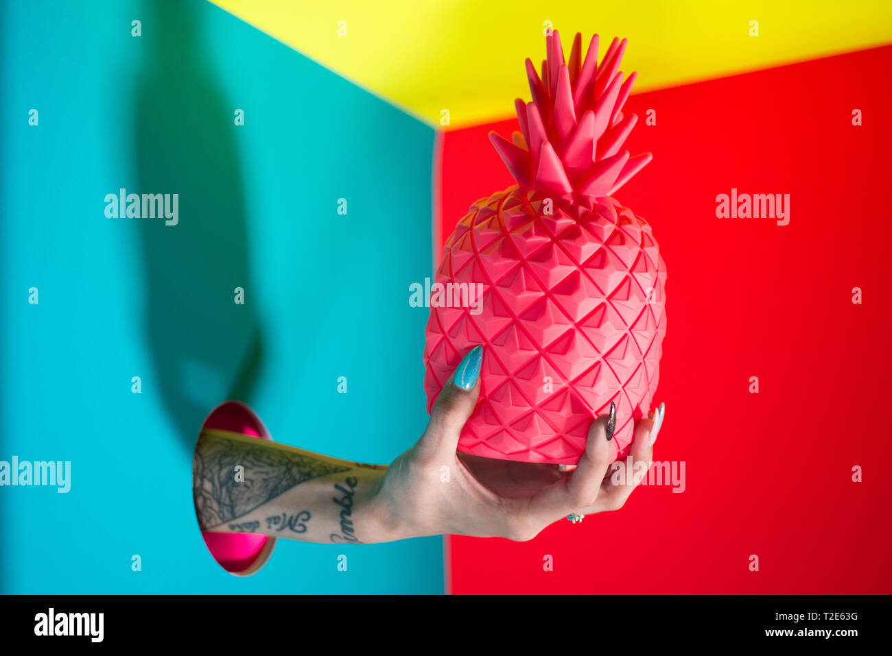 Plastic pineapple held by female hand Stock Photo - Alamy