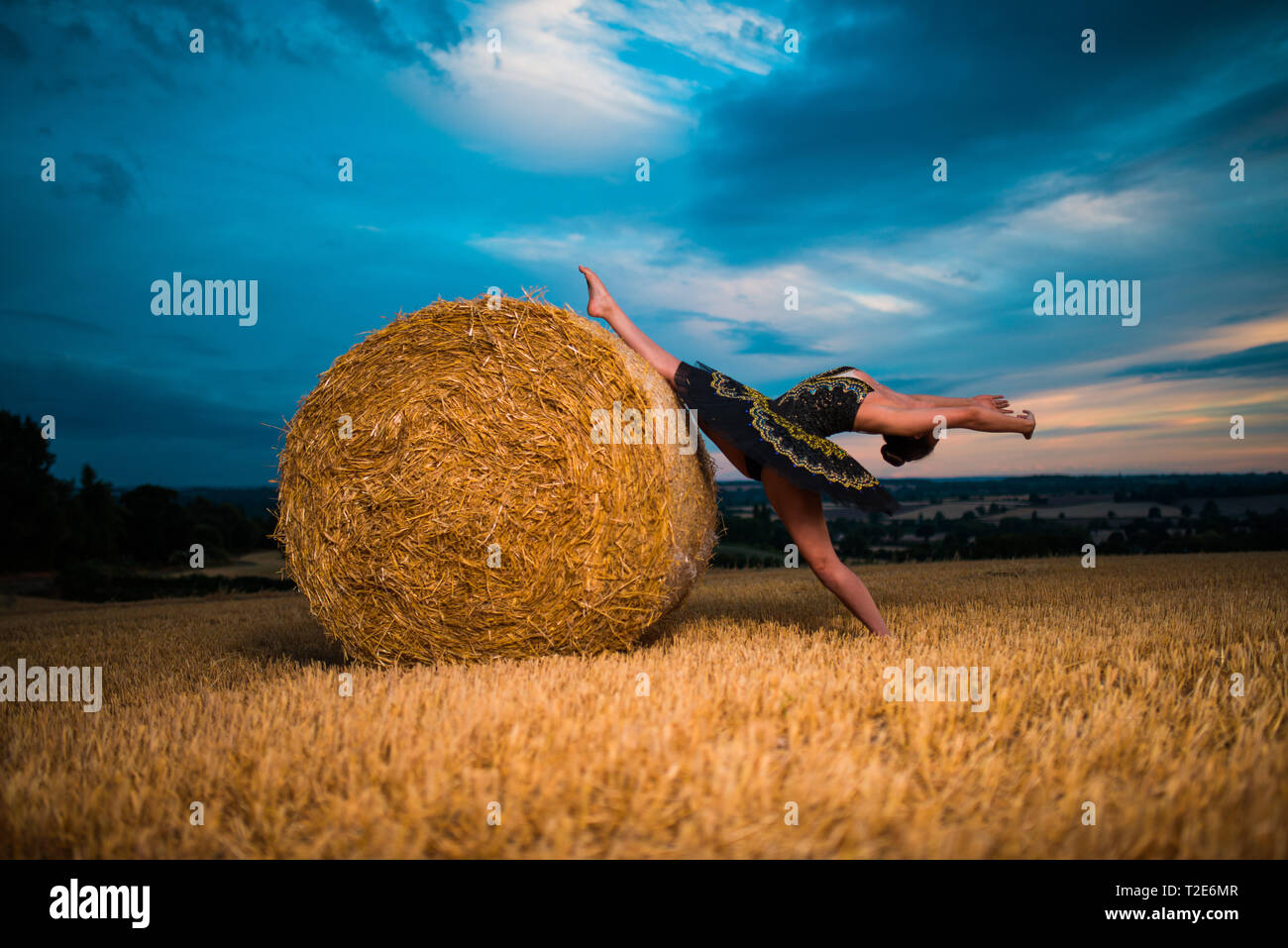 Ballet dancer in field next to hay bale Stock Photo - Alamy