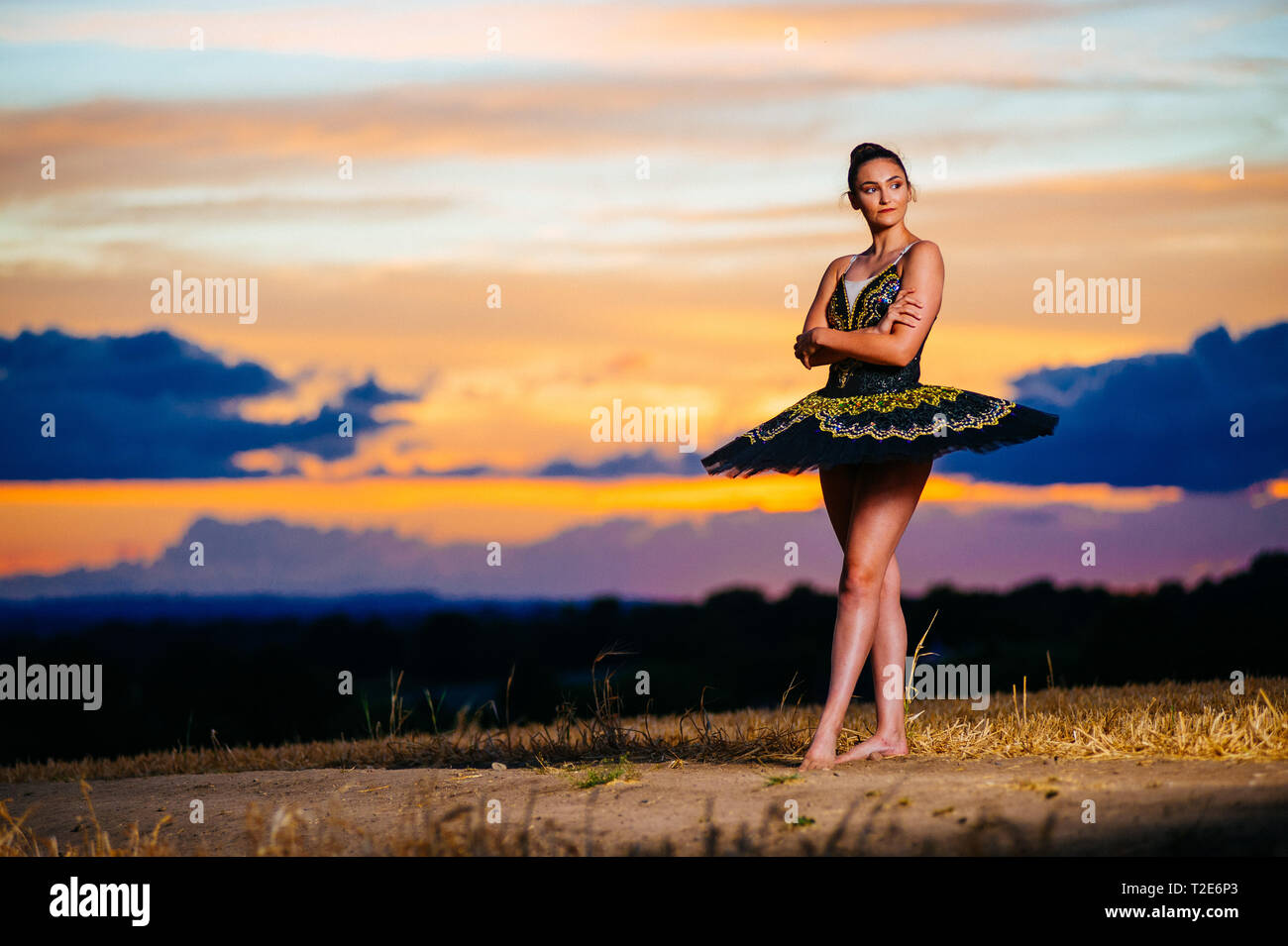 Ballet dancer standing against beautiful sunset Stock Photo - Alamy
