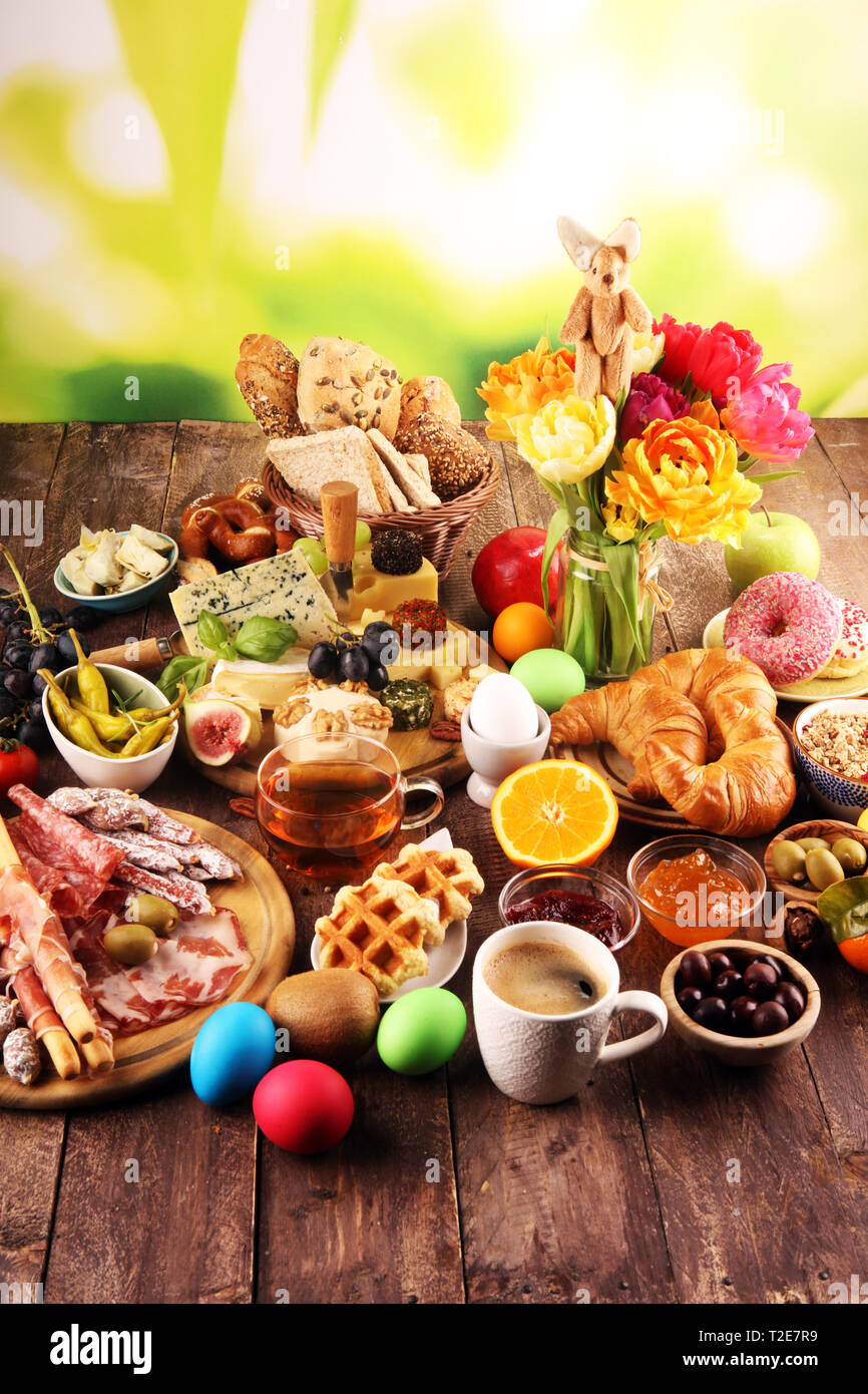 breakfast on table with bread buns, croissants, coffe and donuts Stock ...