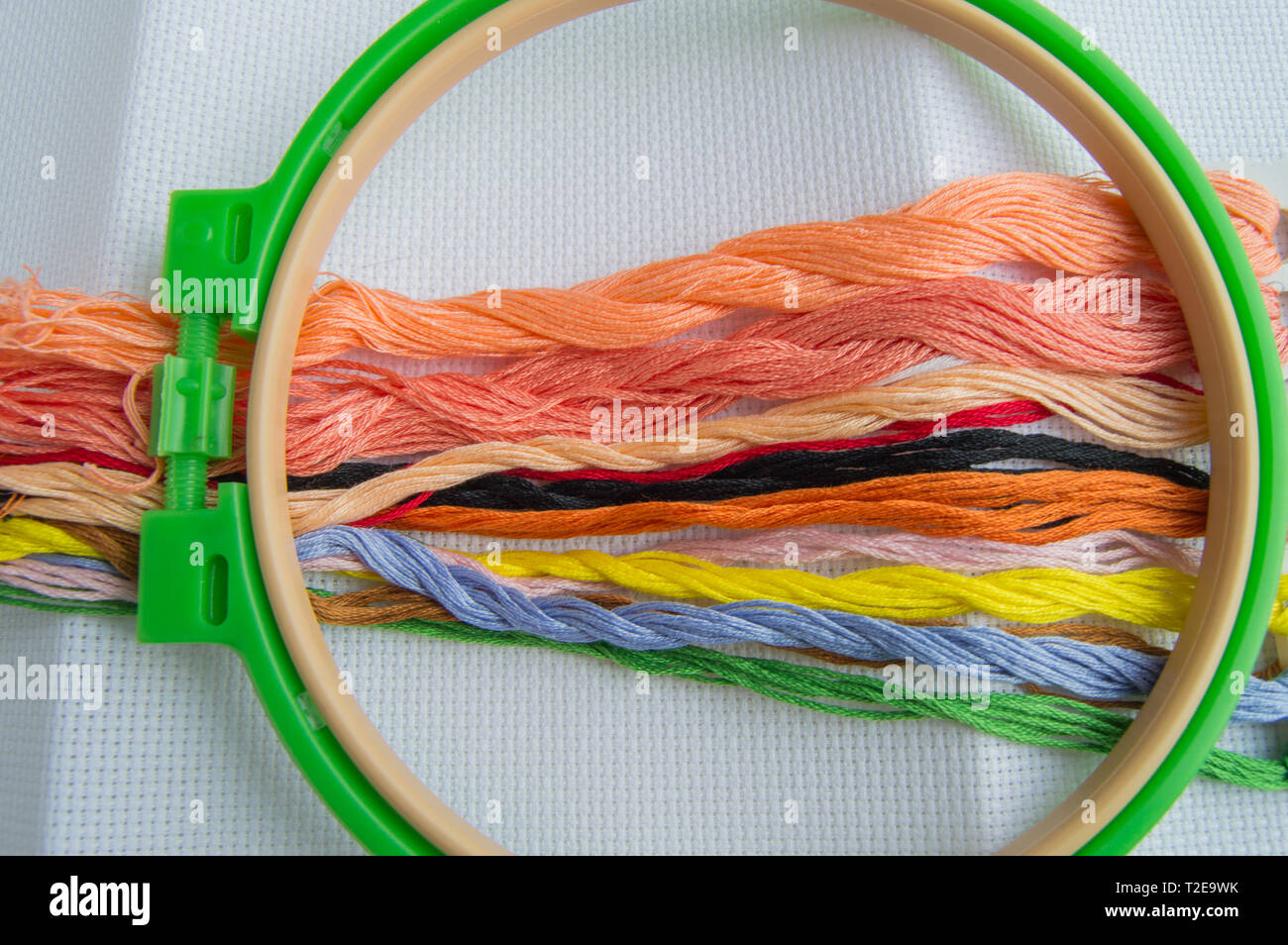 Embroidery Hoop with canvas and bright sewing threads for table ...