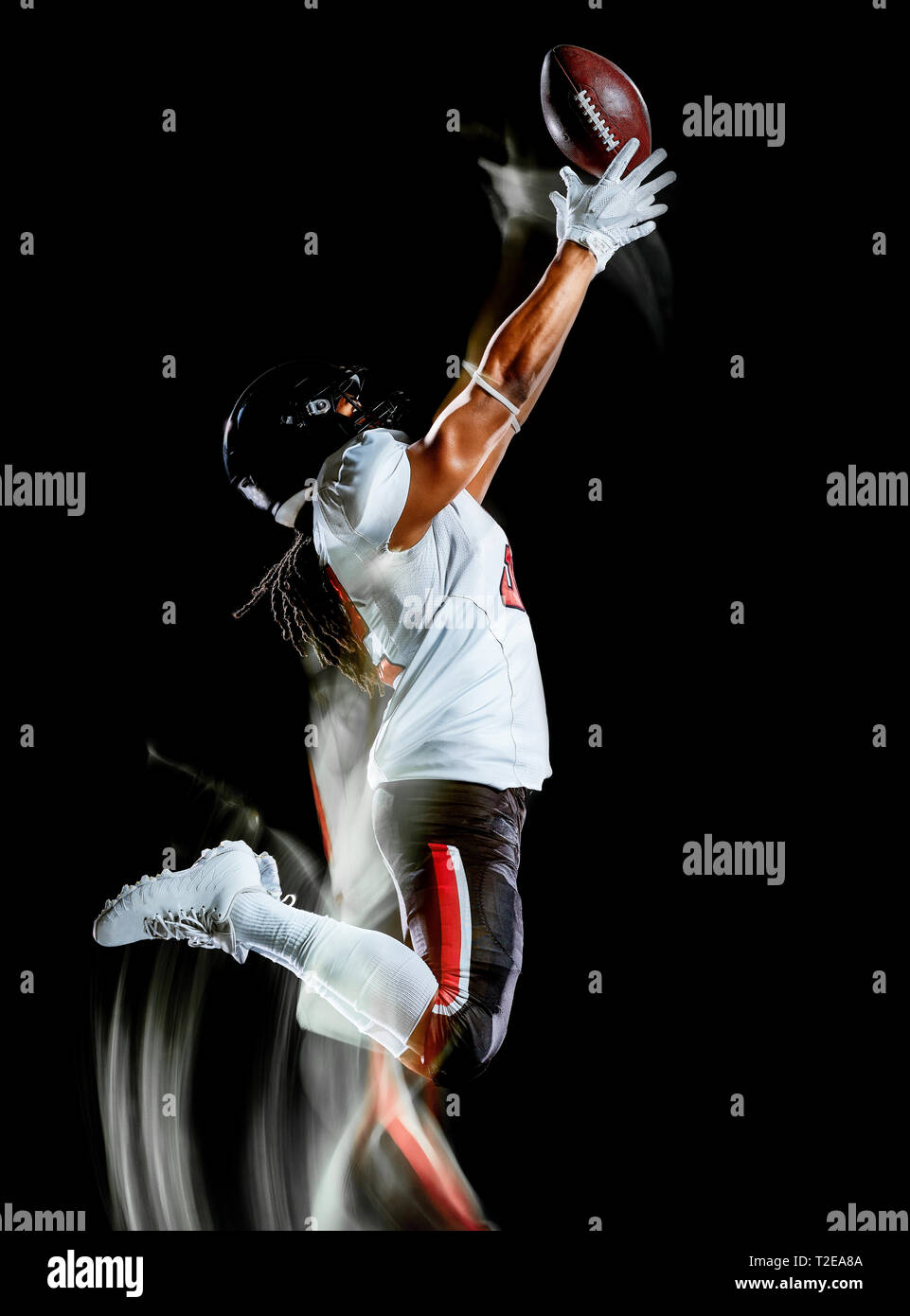 one african american football player man studio shot isolated on black ...