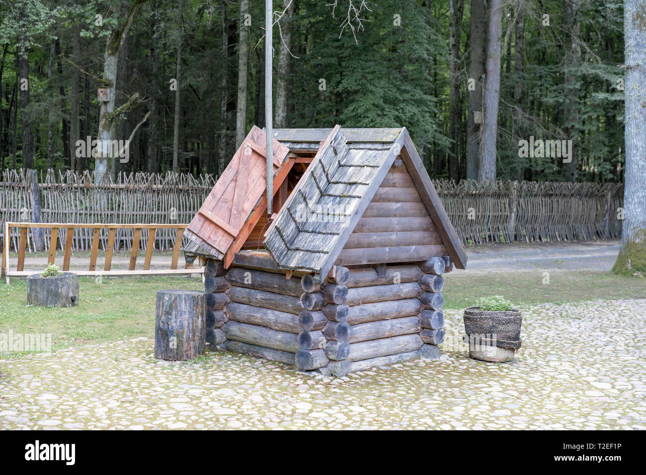 Old water well with pulley closed by wooden shutter Stock Photo - Alamy