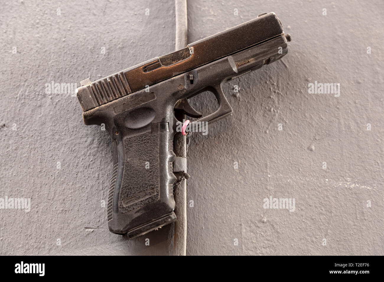 Close-up plastic toy gun made of plastic fastened with a yoke to the ...