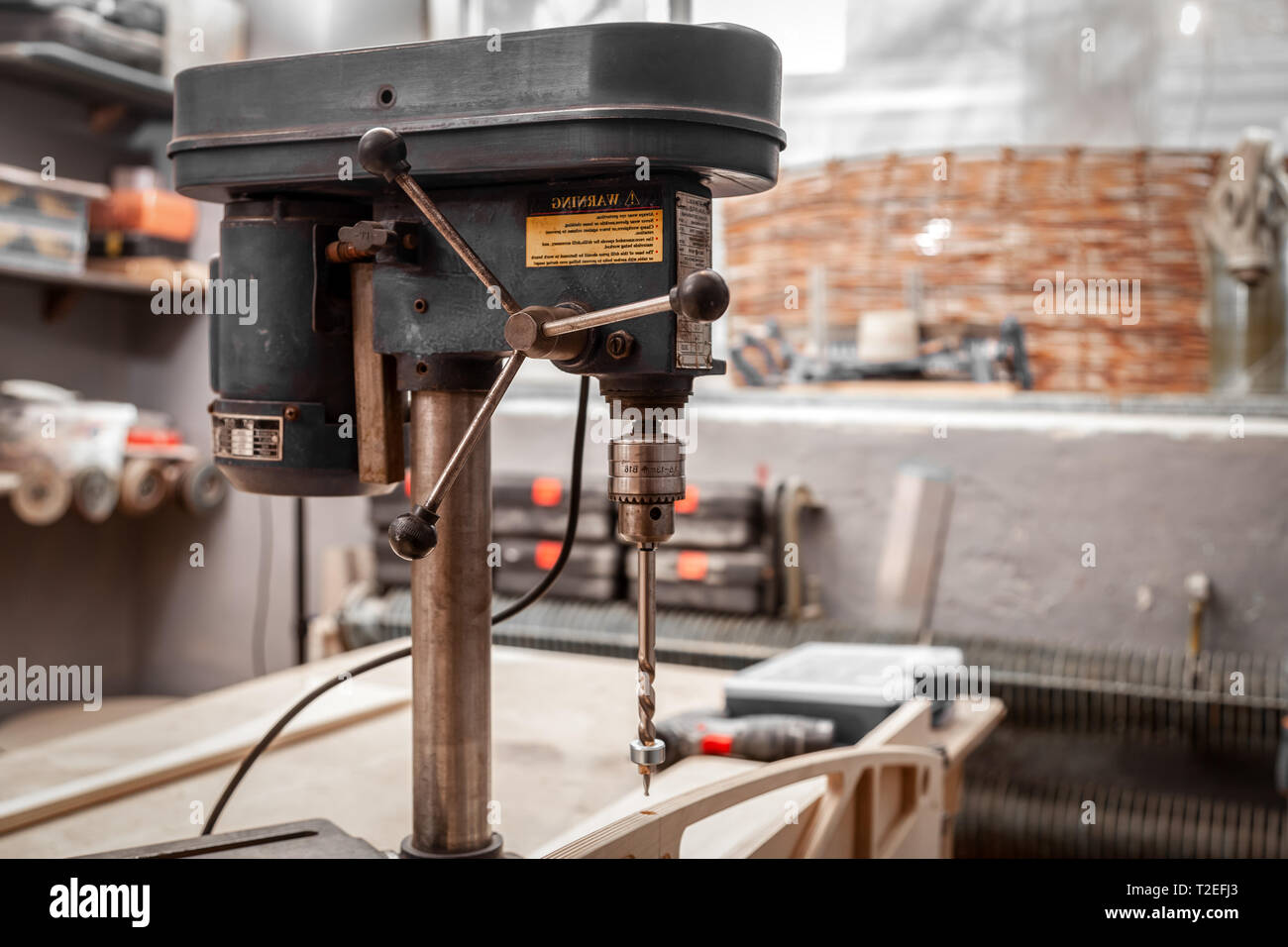 Industrial Iron drill ready for work in workshop interior. Close up on ...