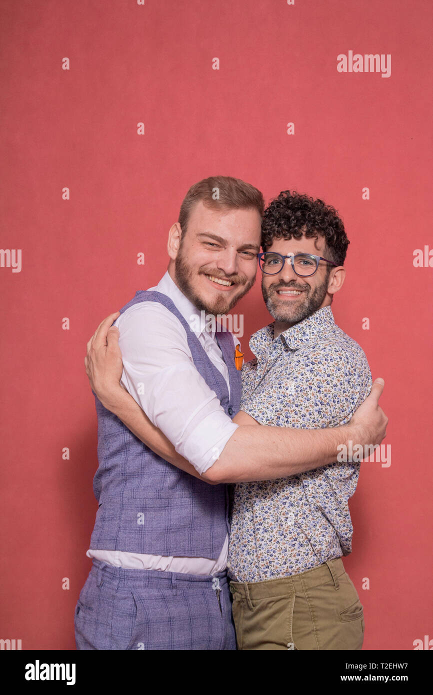 Gay couple hugging looking to camera hi-res stock photography and ...