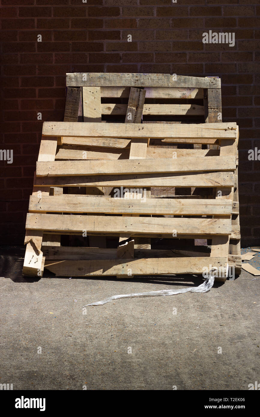 Large Broken Timber Pallets Leaning Against Brick Wall Stock Photo - Alamy