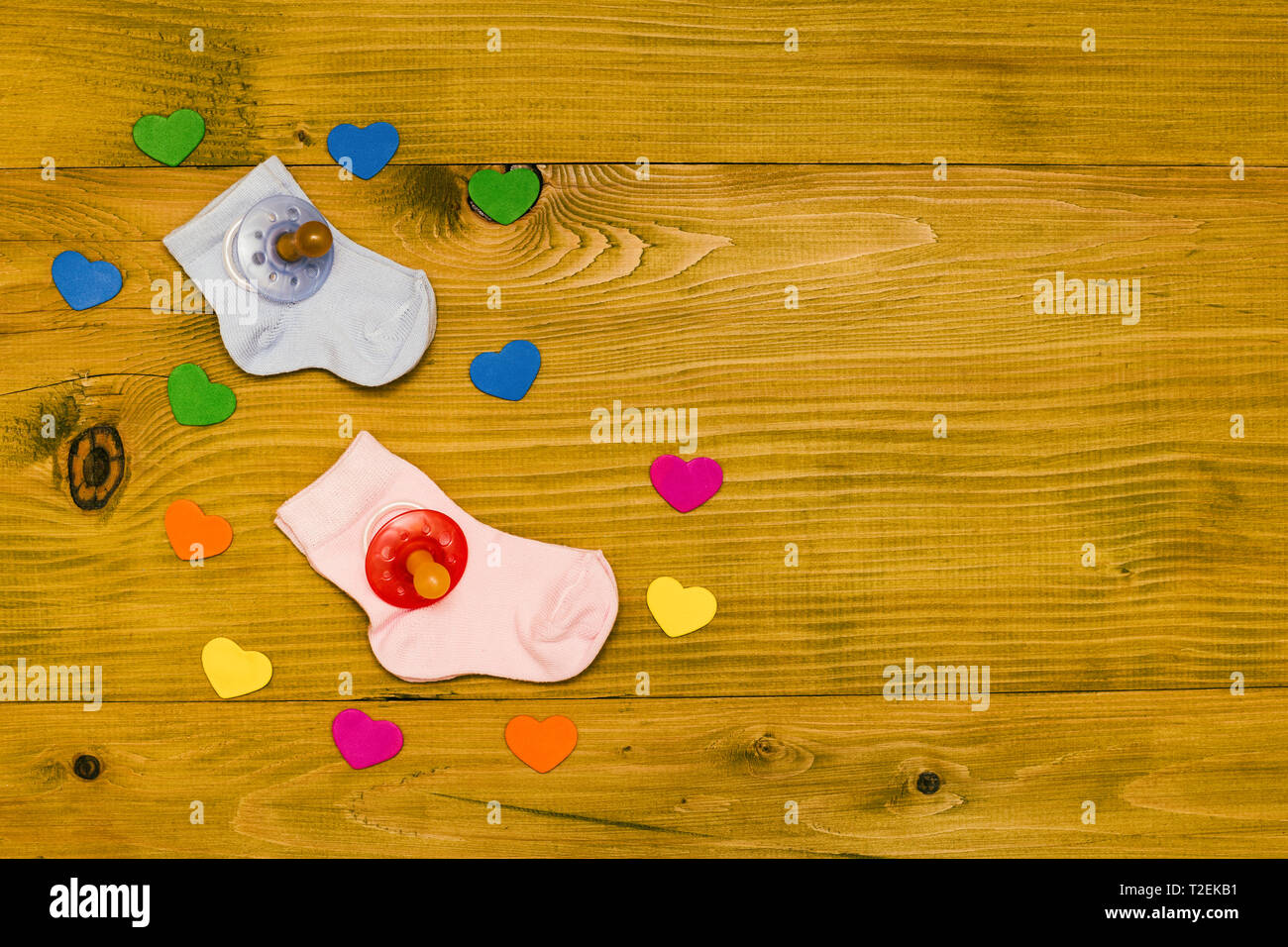 Baby supplies for boy and girl and heart shapes on wooden table.Baby ...