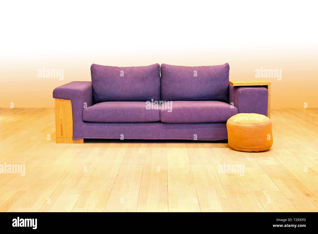 Purple textile sofa ant stool in empty room Stock Photo - Alamy