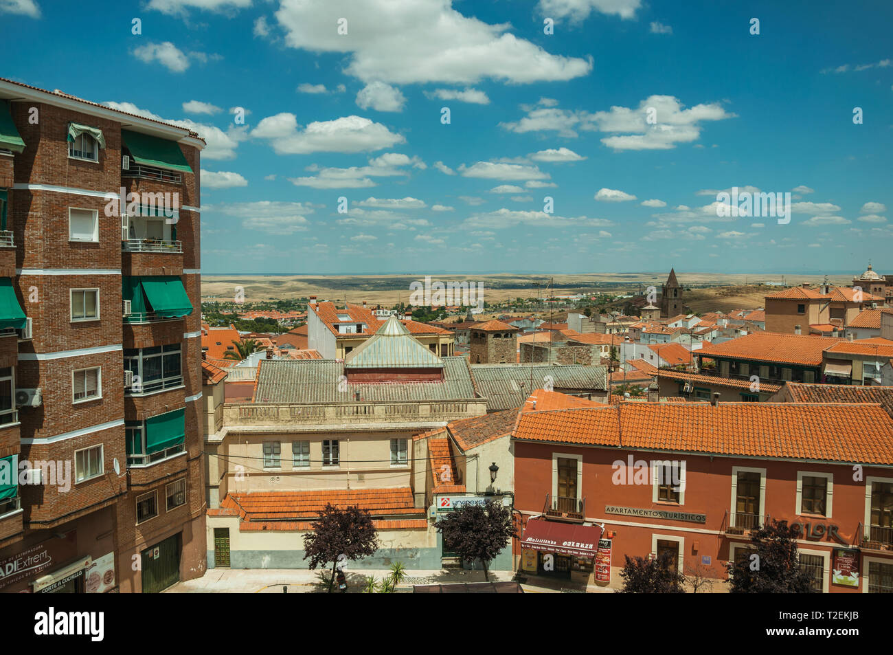 Cityscape with building facade and countryside fields on a sunny day at ...