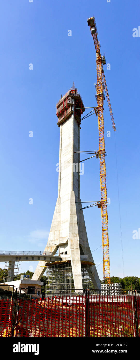 Enclosed construction site of a tall tower Stock Photo - Alamy