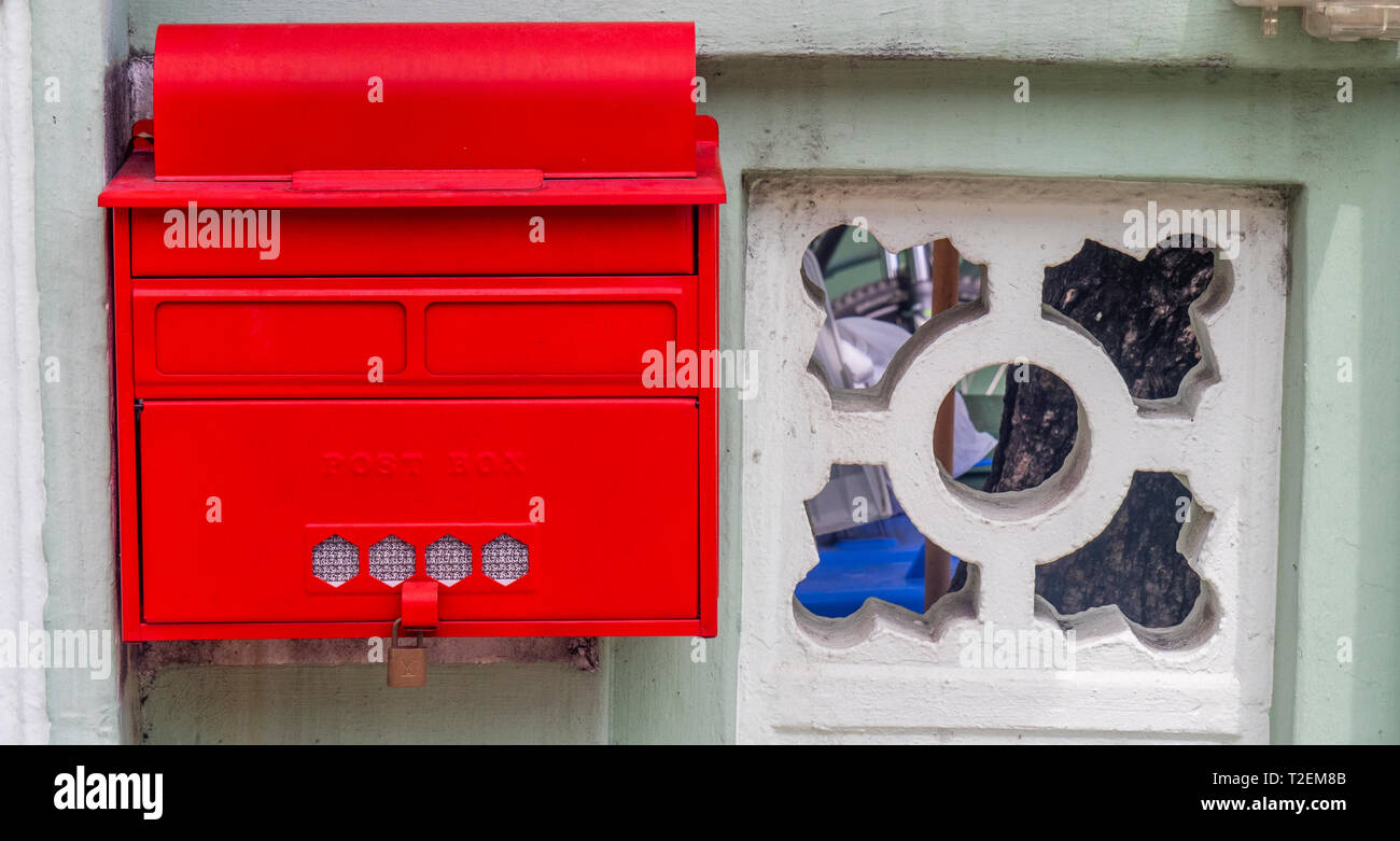 Red letterbox on the front wall of Peranakan terrace house on Koon Seng ...