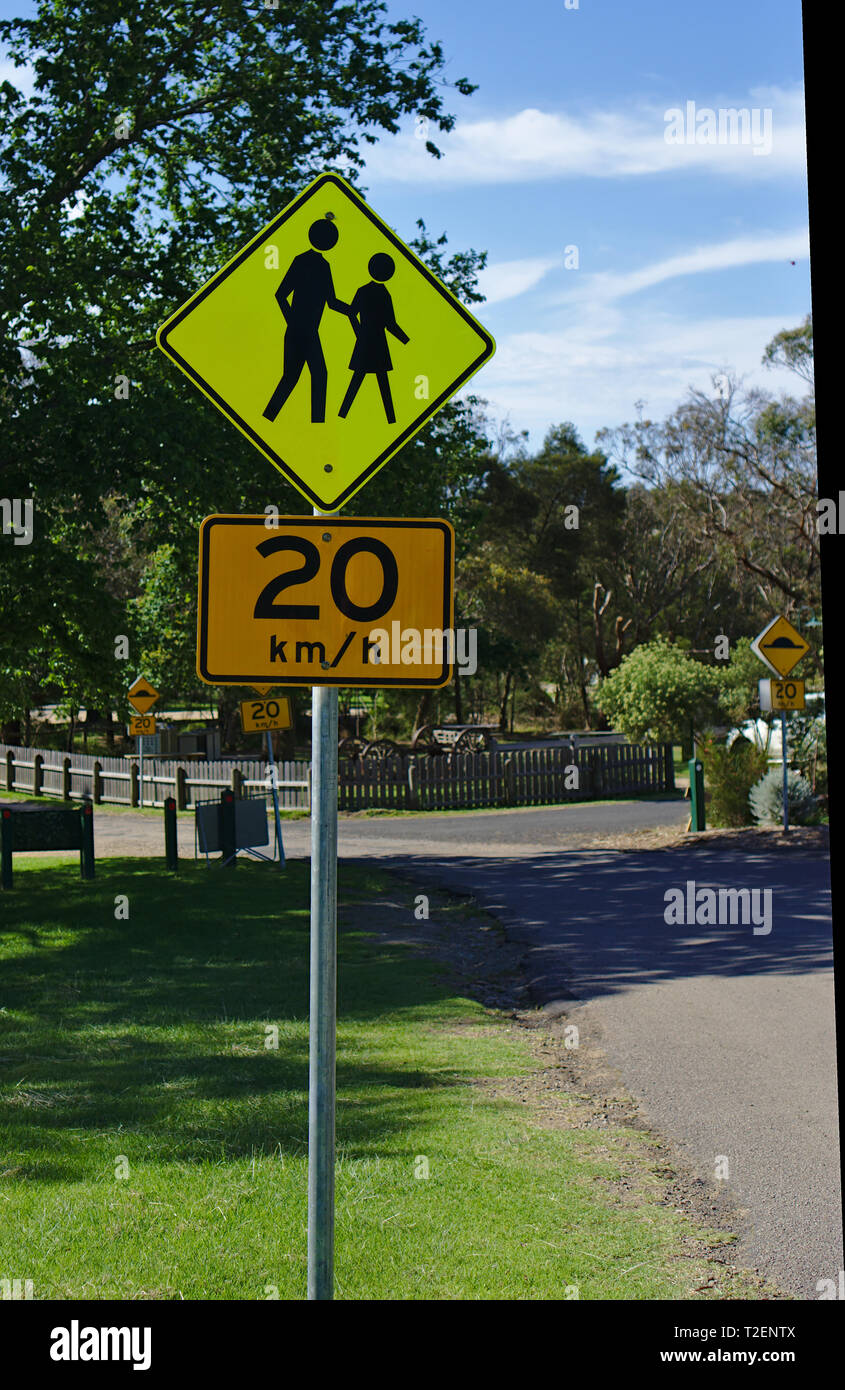Speed limit 20 and pedestrian area sign in yellow and orange color ...