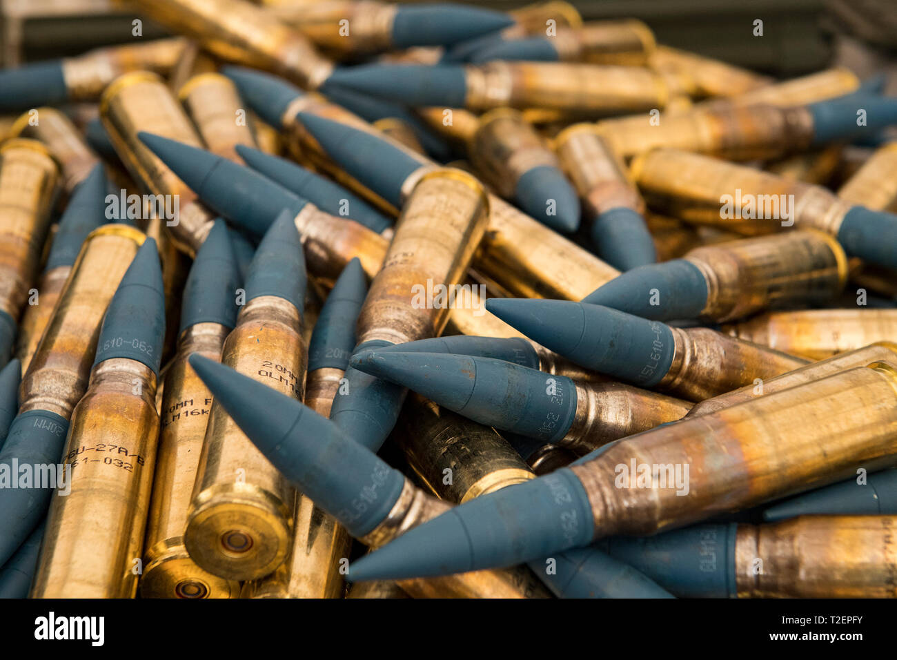 A pile of 20mm rounds rest on a table to be counted by Airmen from the ...