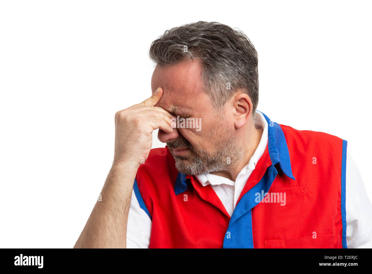 Closeup of male supermarket or hypermarket employee with headache ...