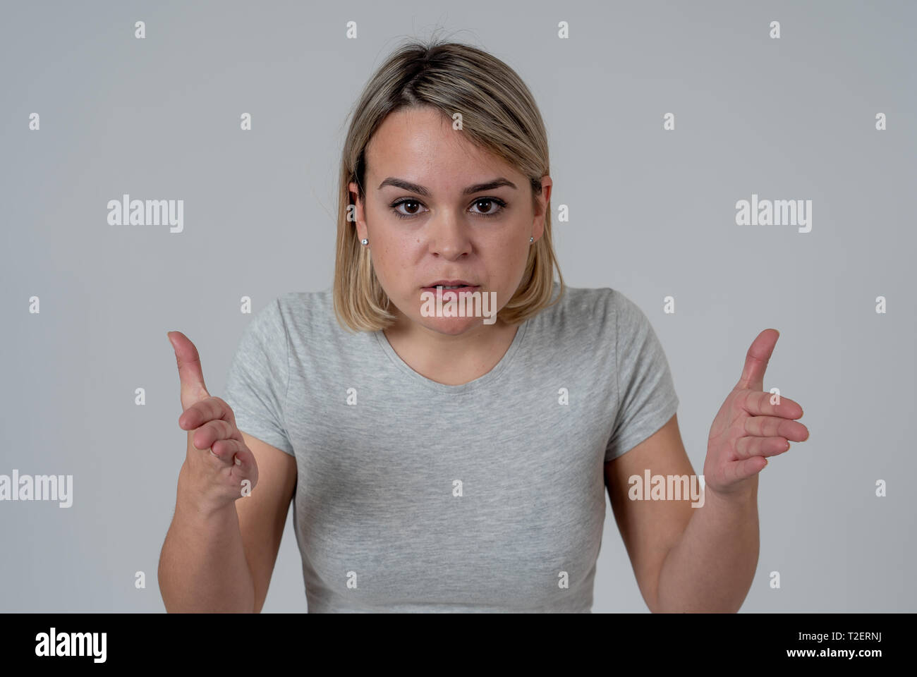 Close up of young attractive caucasian woman with an angry face ...
